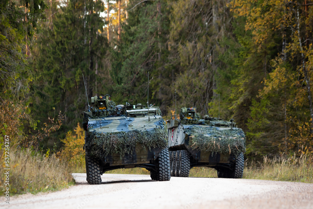 Military training on the battlefield with armored vehicles drives on ...