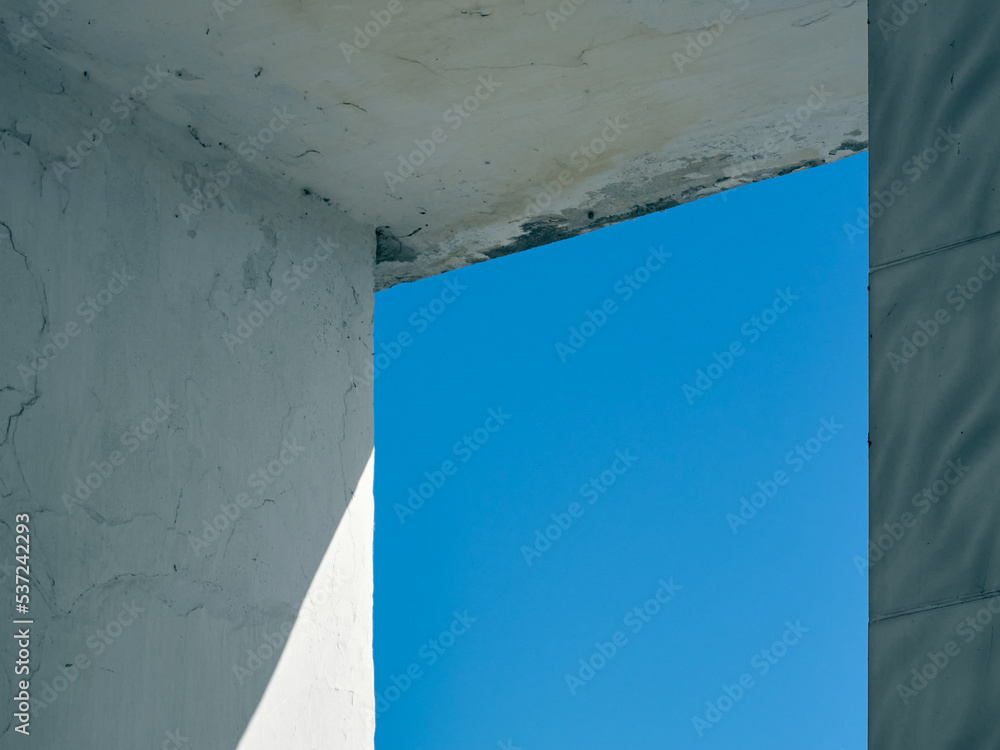 The corner of an old building between a square column and a wall, in ...