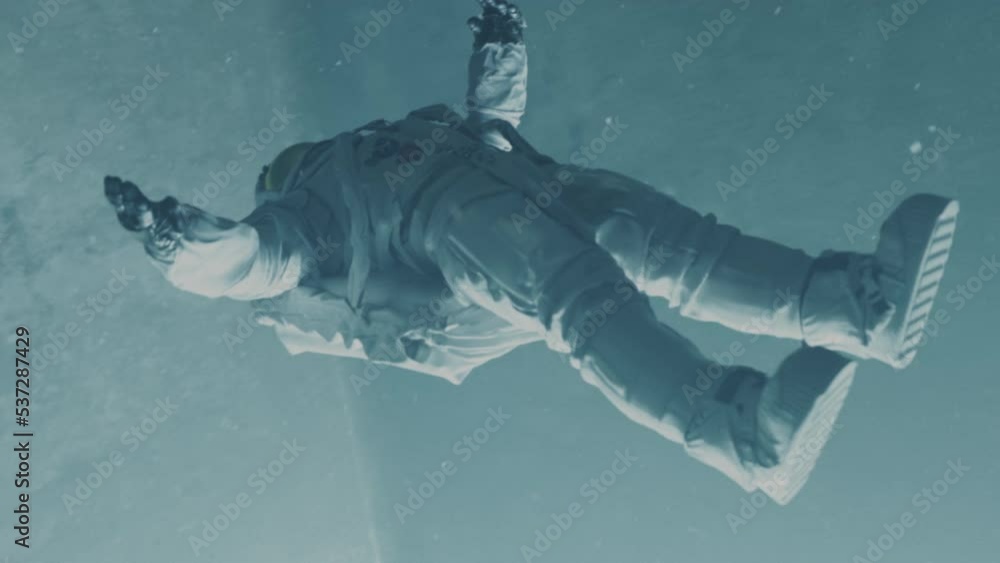 Astronaut falling down a bright path or a tunnel. Sci-fi animation ...