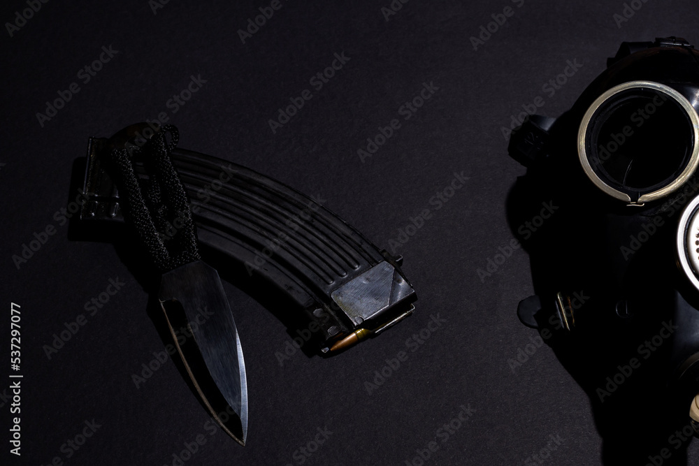 Military equipment, a black knife, a gas mask, a magazine for a machine ...