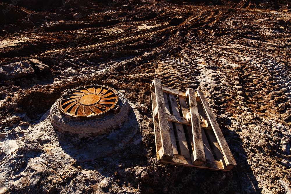 Sewer manhole on a land plot intended for building houses. Installation ...