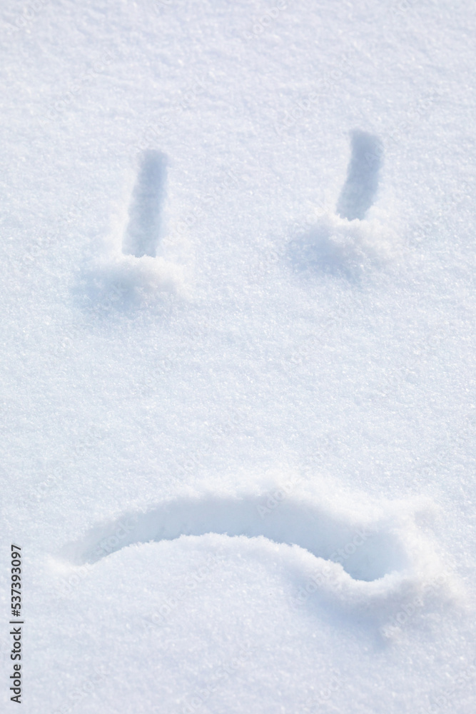 Sad smile. A symbolic drawing of a sorrowful face with in the snow. The ...