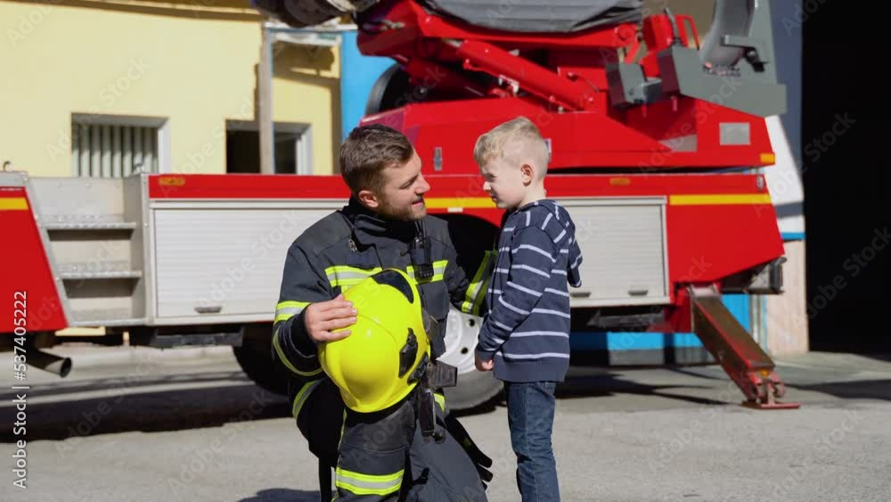 Video „Little boy with firefighter in protective uniform in fire ...