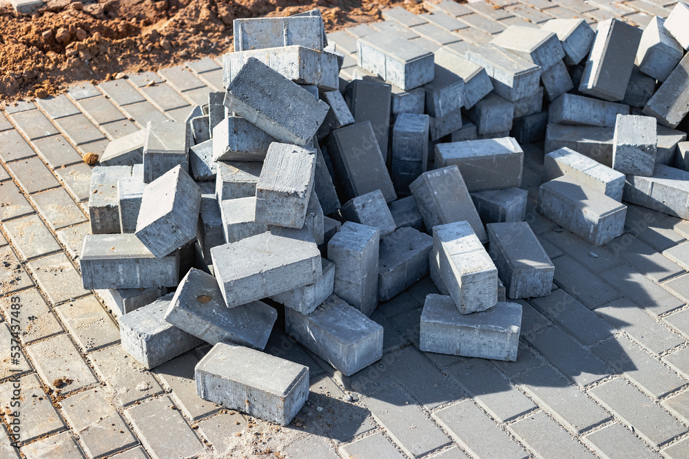 Pavement repairs and paving slabs laying on the prepared surface, with ...