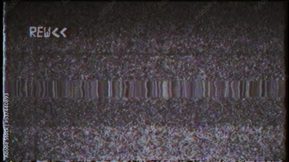 An overlay featuring a black and white VHS rewind effect and noise ...