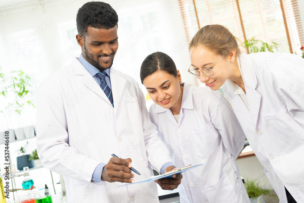 Scientists are taking notes. Happy teams of scientists experiment and ...