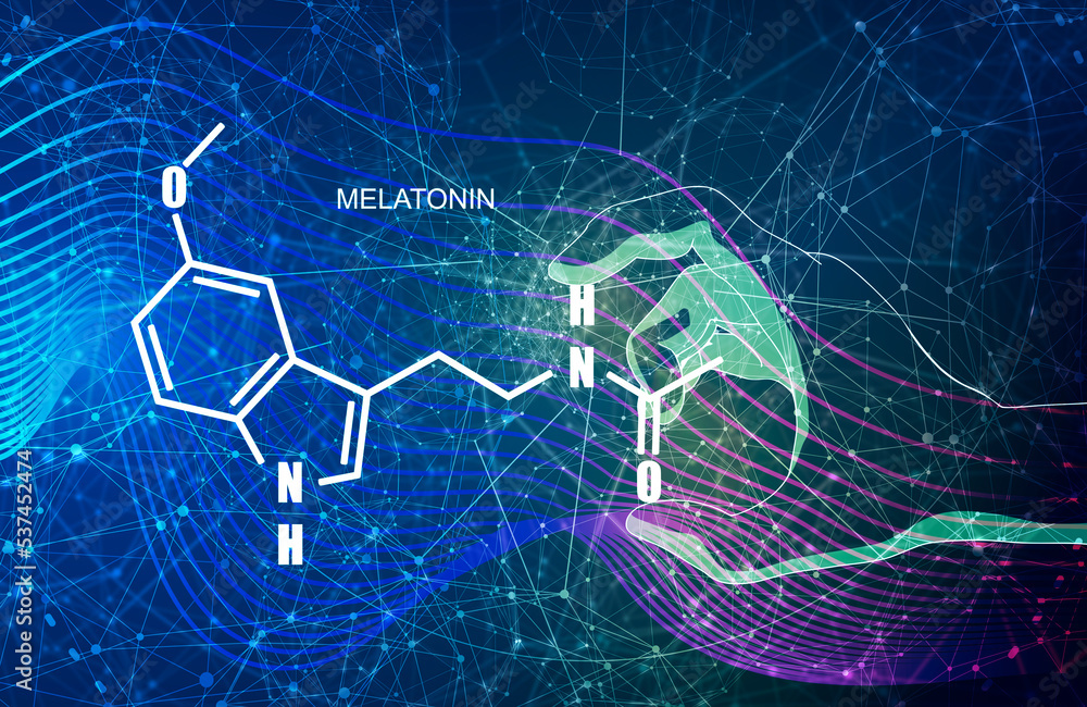 Hand holding chemical molecular formula of hormone melatonin. In humans ...