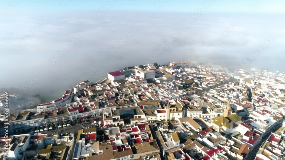 Slow aerial dolly shot to the back over the old town medina sidonia in ...