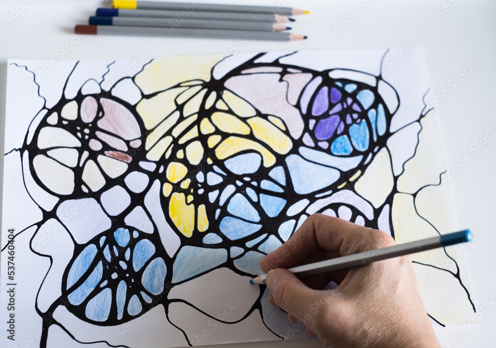 Abstract neurographic drawing. A woman draws a neurographic drawing on ...