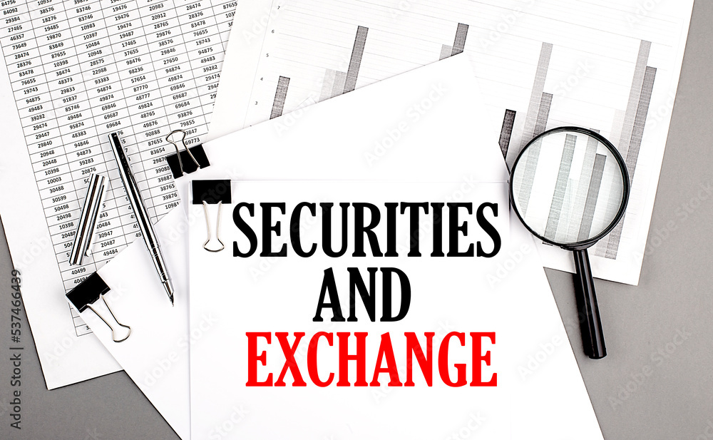 SECURITIES AND EXCHANGE text on paper on chart background Stock Photo ...