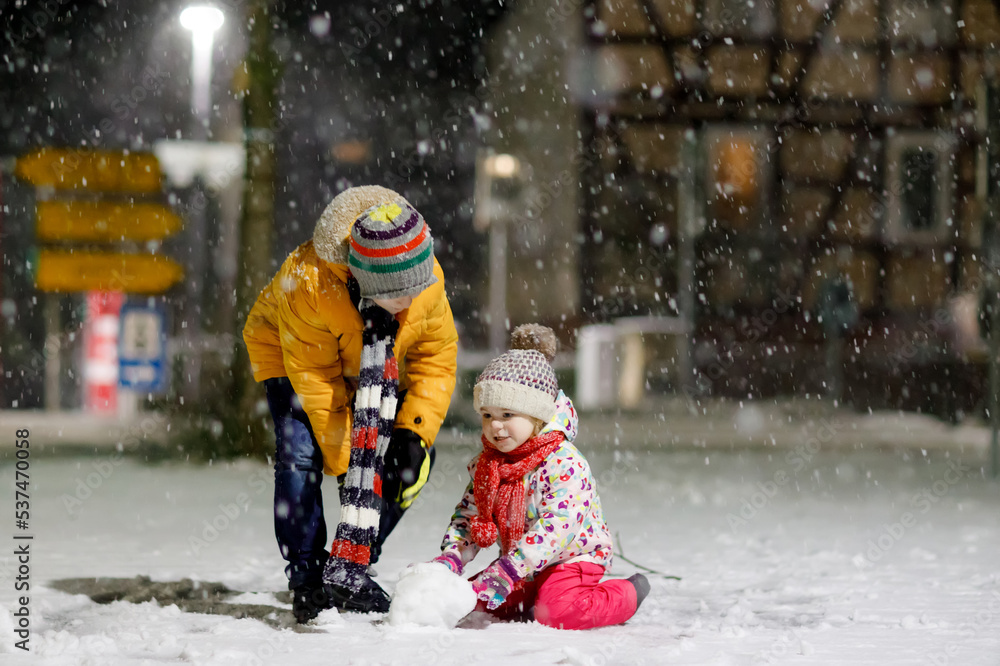 Little school kid boy and cute toddler girl sitting together playing ...