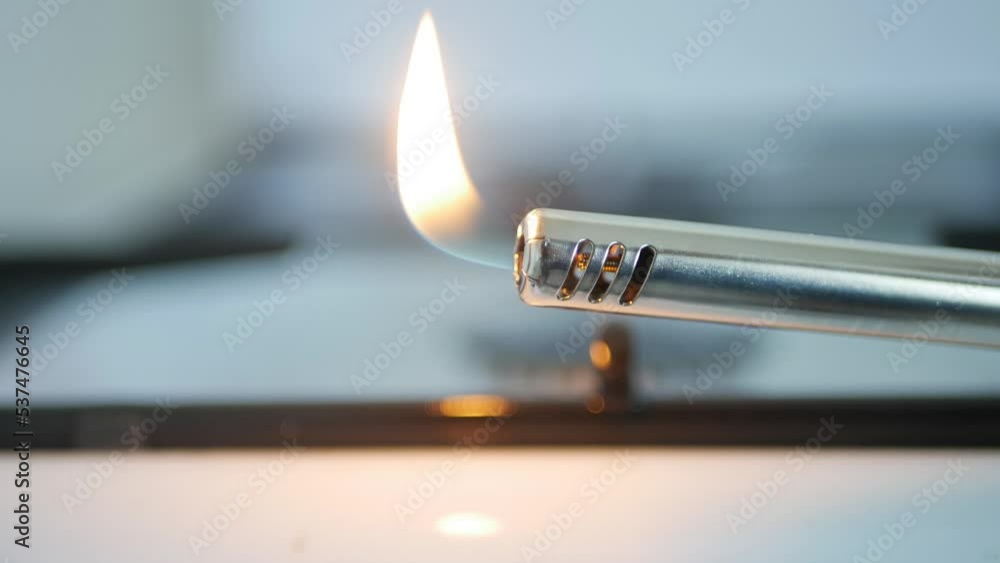 A Man Lighting Up Fire at Gas Cooker with a Lighter. Close-up shooting ...