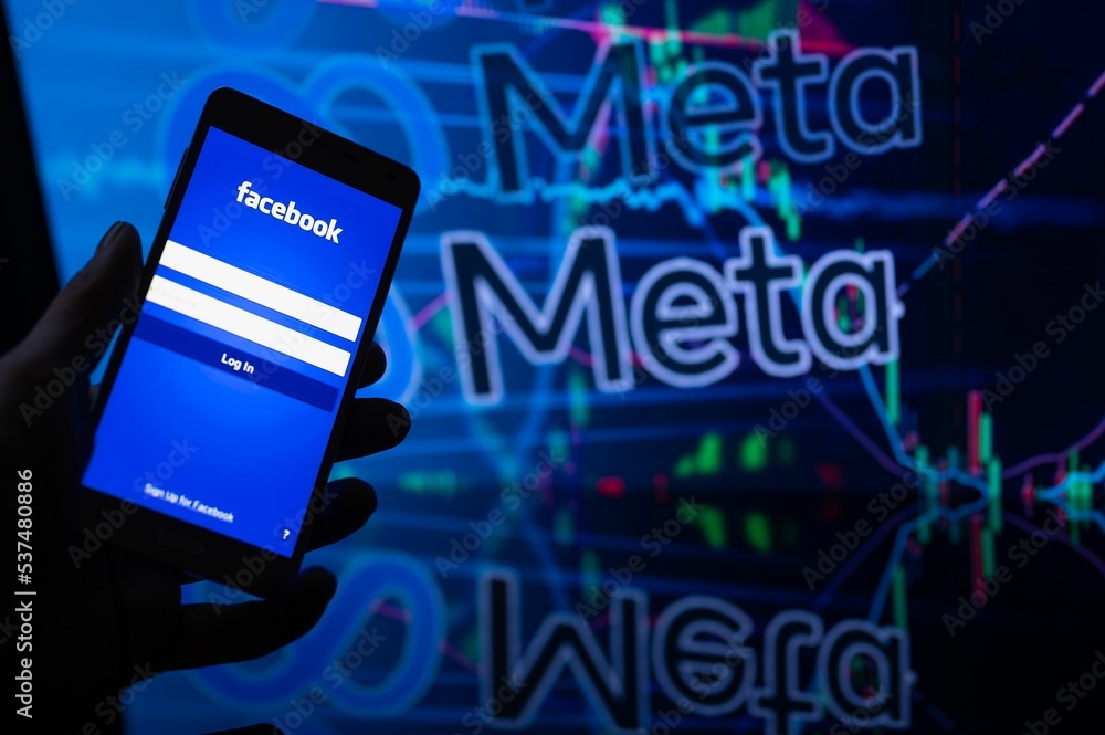Smartphone with Facebook login screen and Meta logo in the background ...
