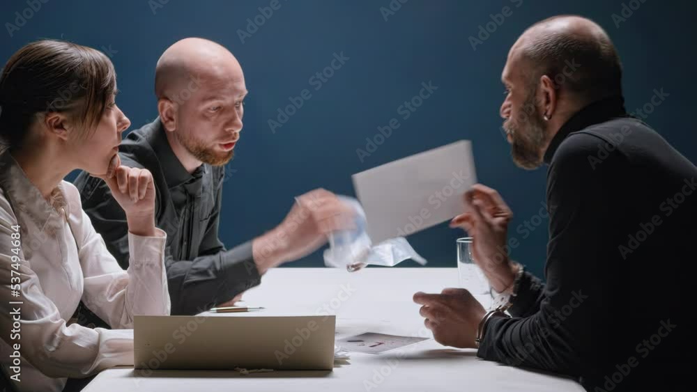 Two detective cops interrogate murder suspect. Police officer shows ...