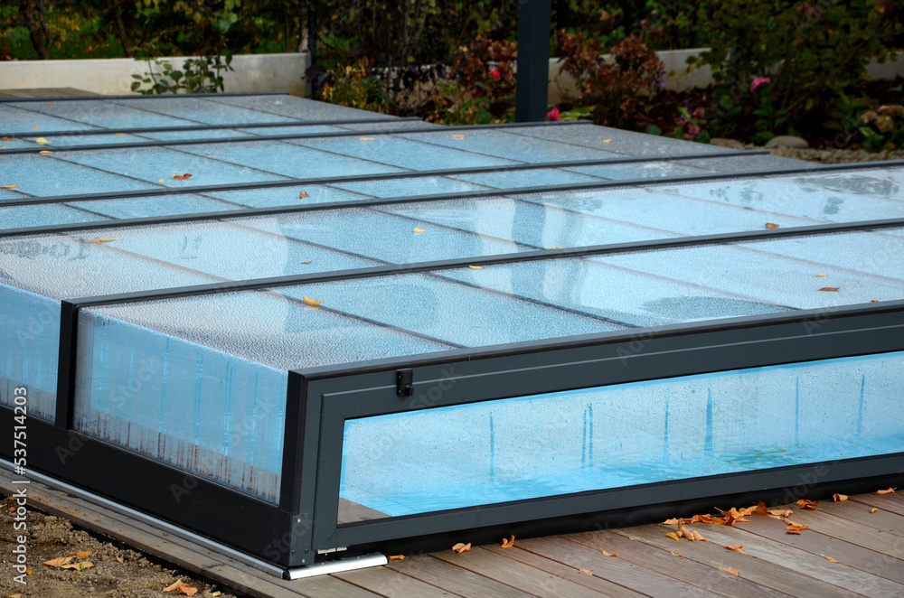 folding pool roof. the cover made of aluminum and plexiglass runs on ...