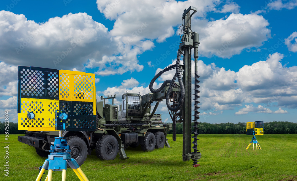 Construction equipment. Machine is drilling well in middle green lawn ...