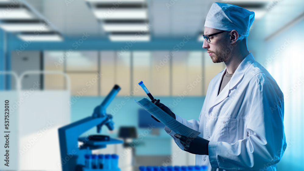 Geneticist is holding blood sample. Male geneticist in white coat ...