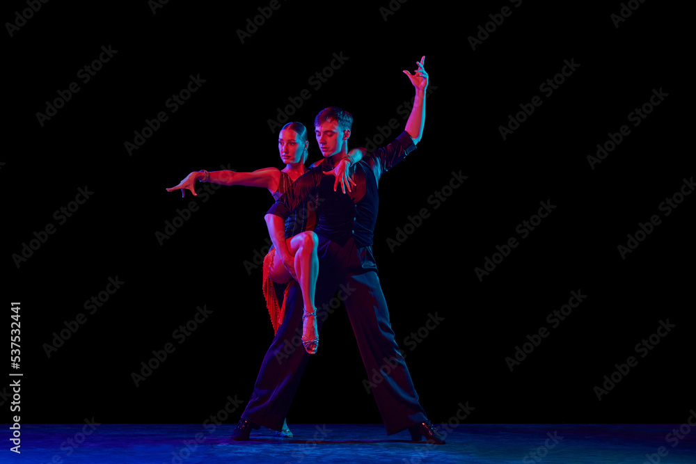 Two dancing people, ballroom dancers in elegance outfits in motion ...