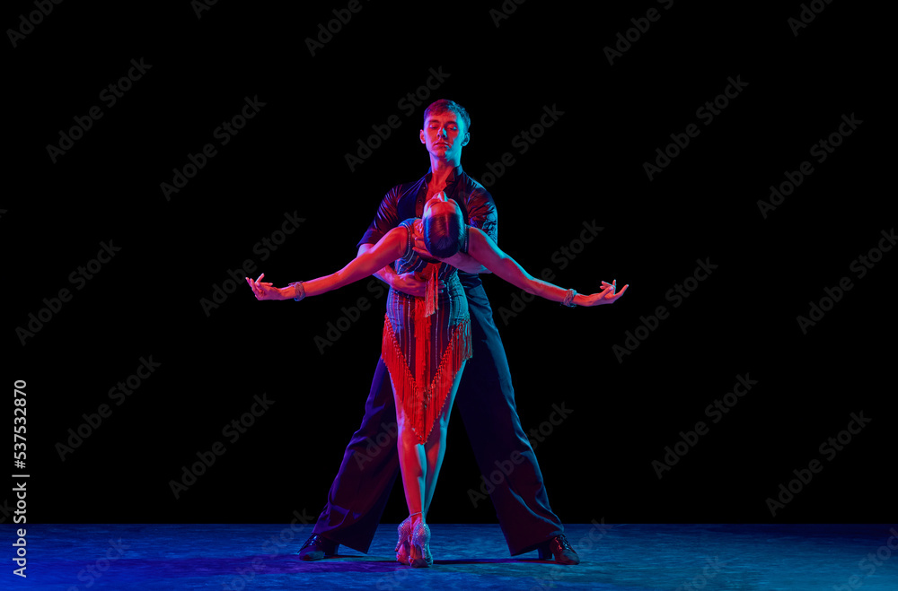 Two dancing people, ballroom dancers in elegance outfits in motion ...