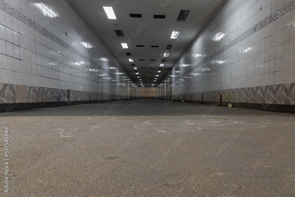 Perspective view of Ambient public underpass with white tiled walls and ...