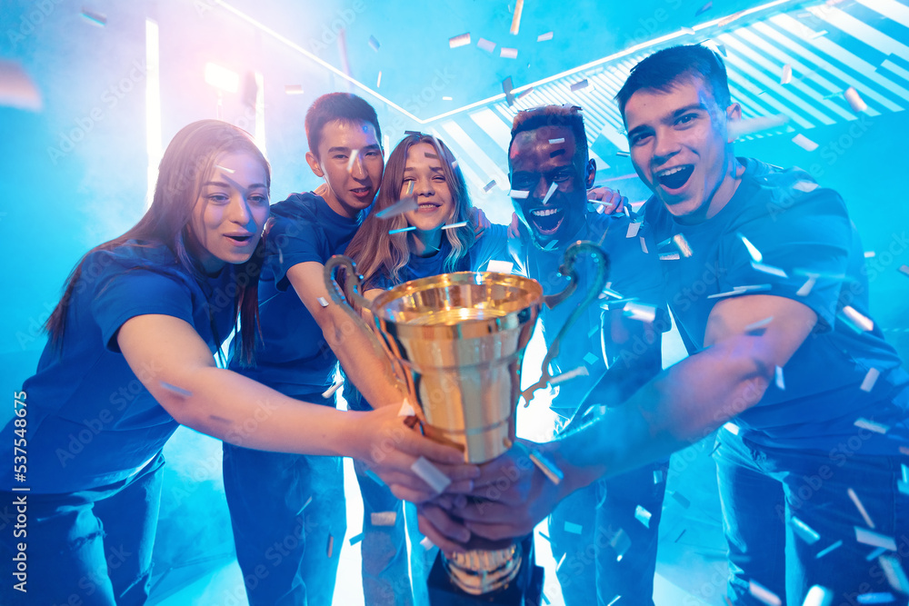 Happy Winner team gamer holding cup trophy prize of victors video games ...