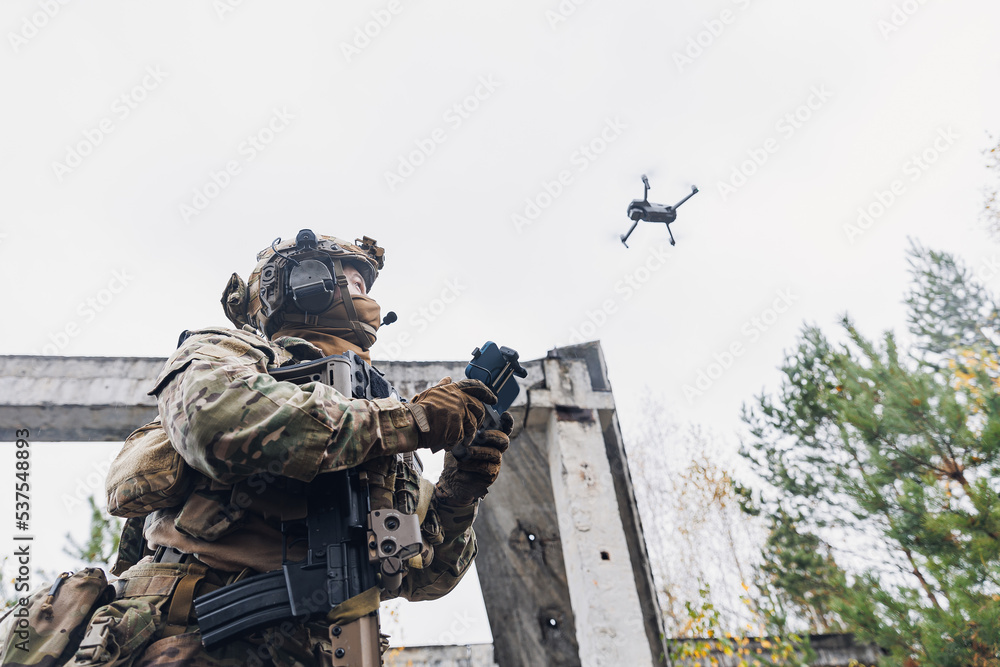 Military soldier controls drone for reconnaissance operation of enemy ...