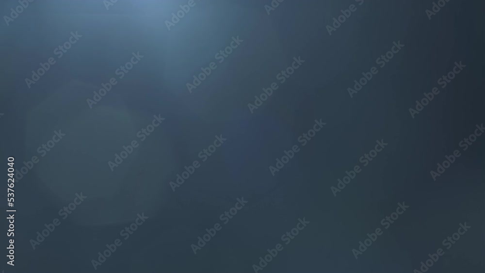 Defocused white lens flare on dark abstract background. Spotlight rays ...