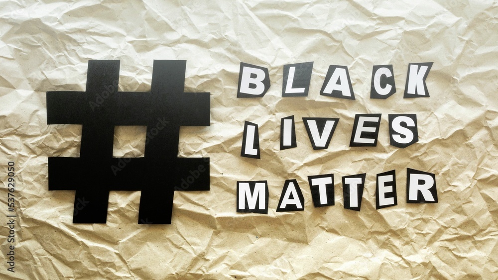 Black lives matter paper letter cutouts with hashtag on a crumpled ...