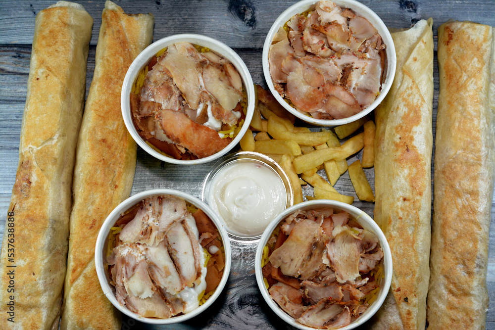 Pieces of Chicken shawarma and yellow Basmati rice, Syrian bread and ...
