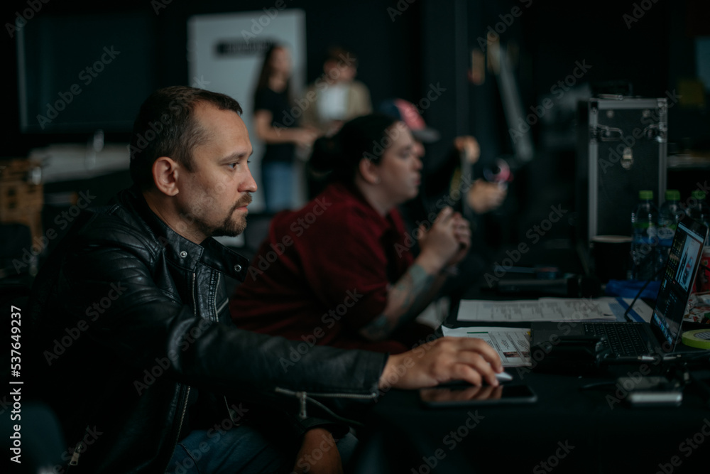 Editing director behind monitors on the set. A video editor edits video ...
