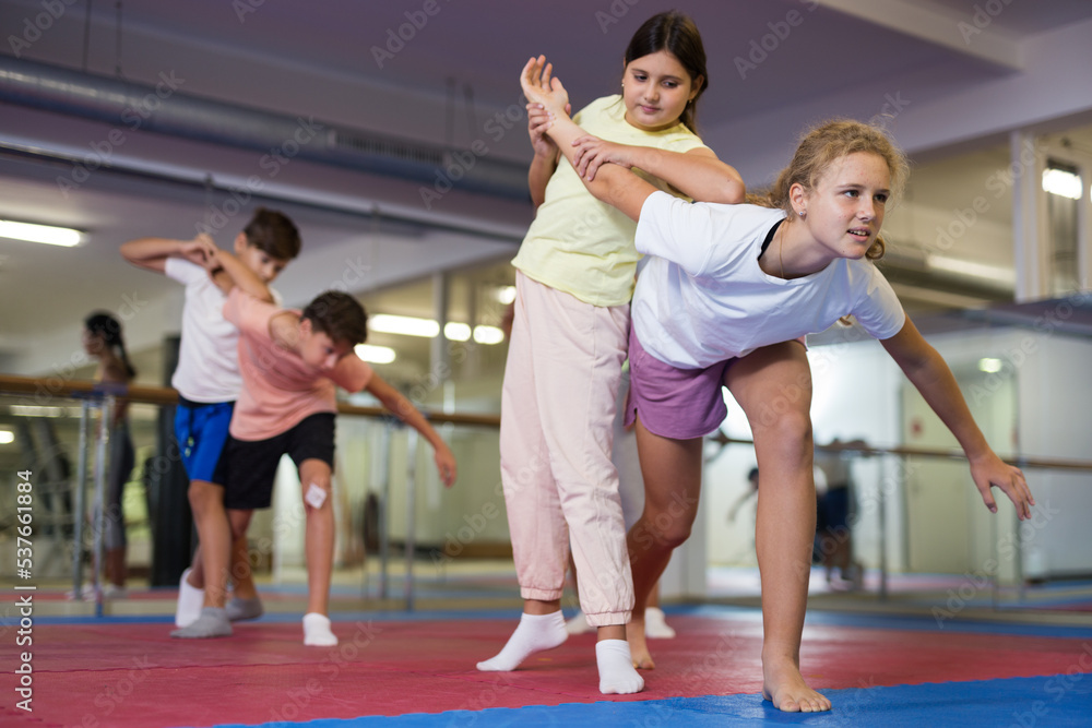 Two girls learn to do a painful hand grip in a self-defense lesson ...