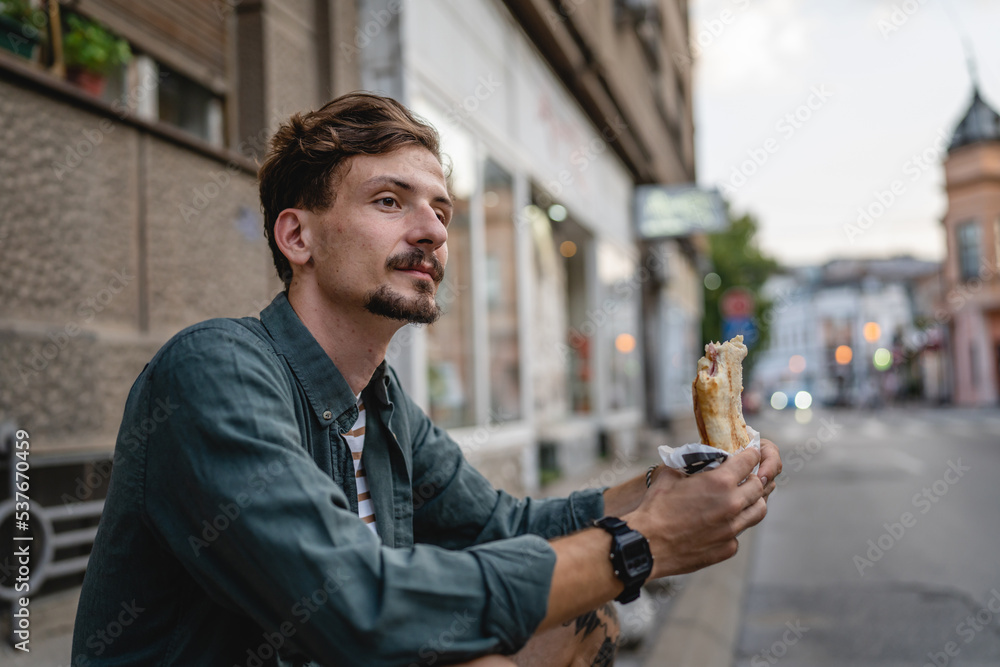 One man young adult modern caucasian male in the city in sunny day ...