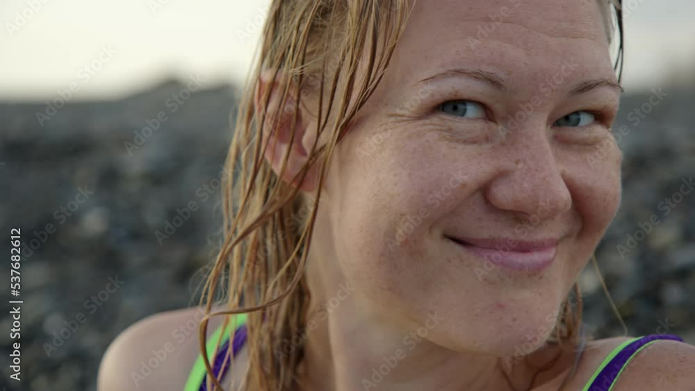 Extreme close up portrait of happy young woman with freckles on her ...