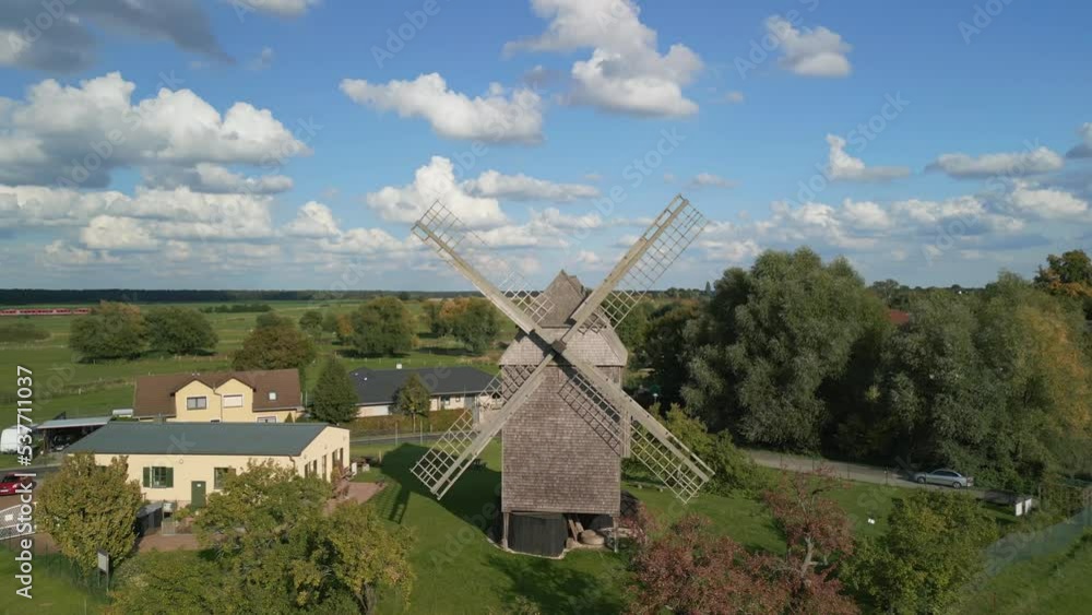 Flat green land, historic buildings. Dramatic aerial view flight ...