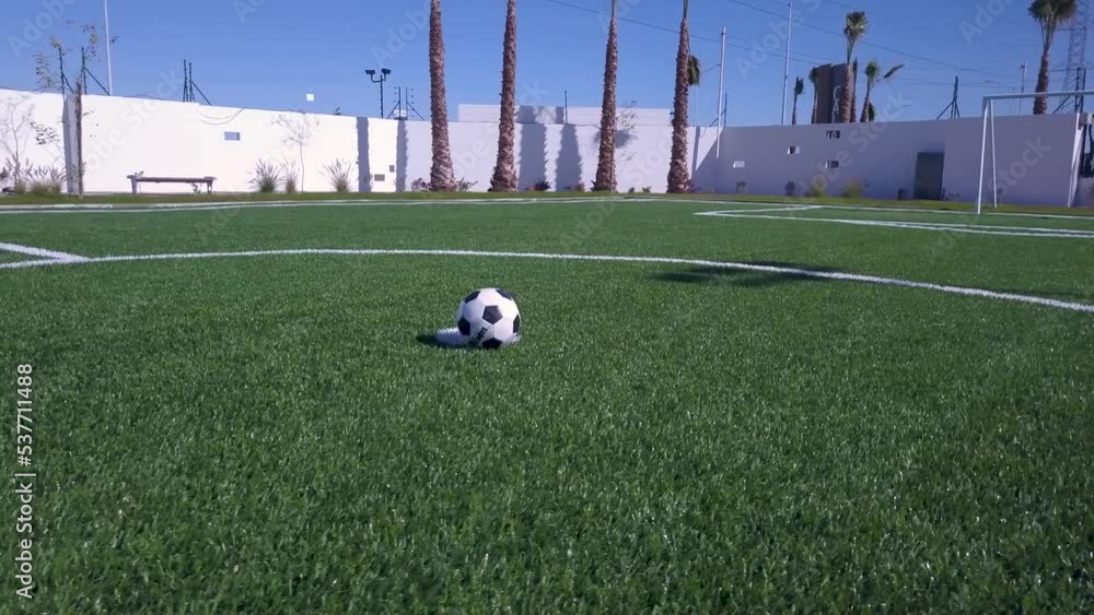 View of a drone flying around a soccer ball in the middle of a soccer ...