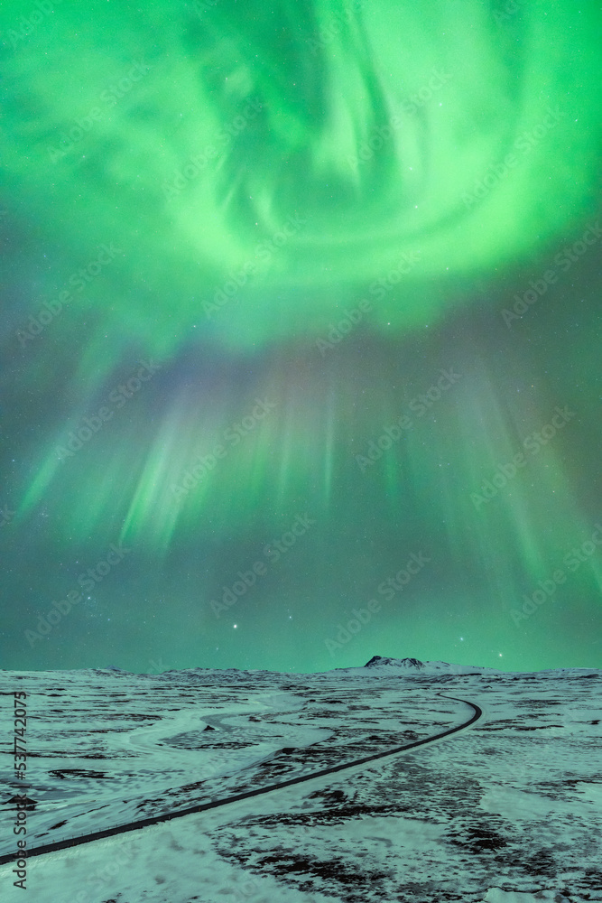 Empty asphalt road amidst field covered with snow under sky with ...