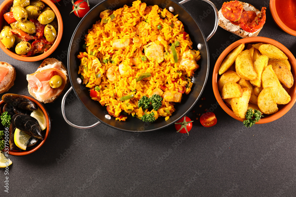 spanish paella and traditional tapas(potato brava, mussels, toast ...