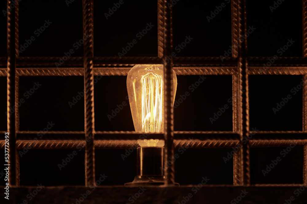 One decorative incandescent light bulb inside loft partition from ...