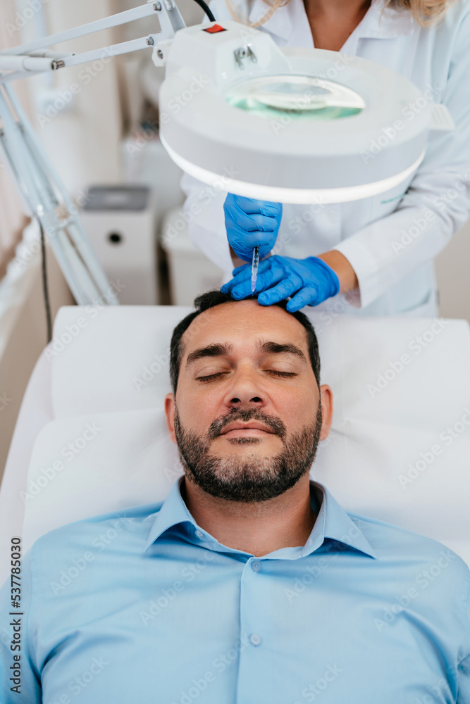 Handsome middle age man receiving advanced Platelet Rich Plasma PRP ...