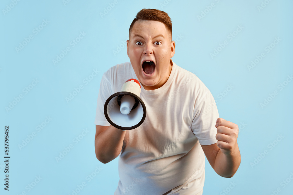 Attention, news. Excited young boy shouting at megaphone isolated on ...