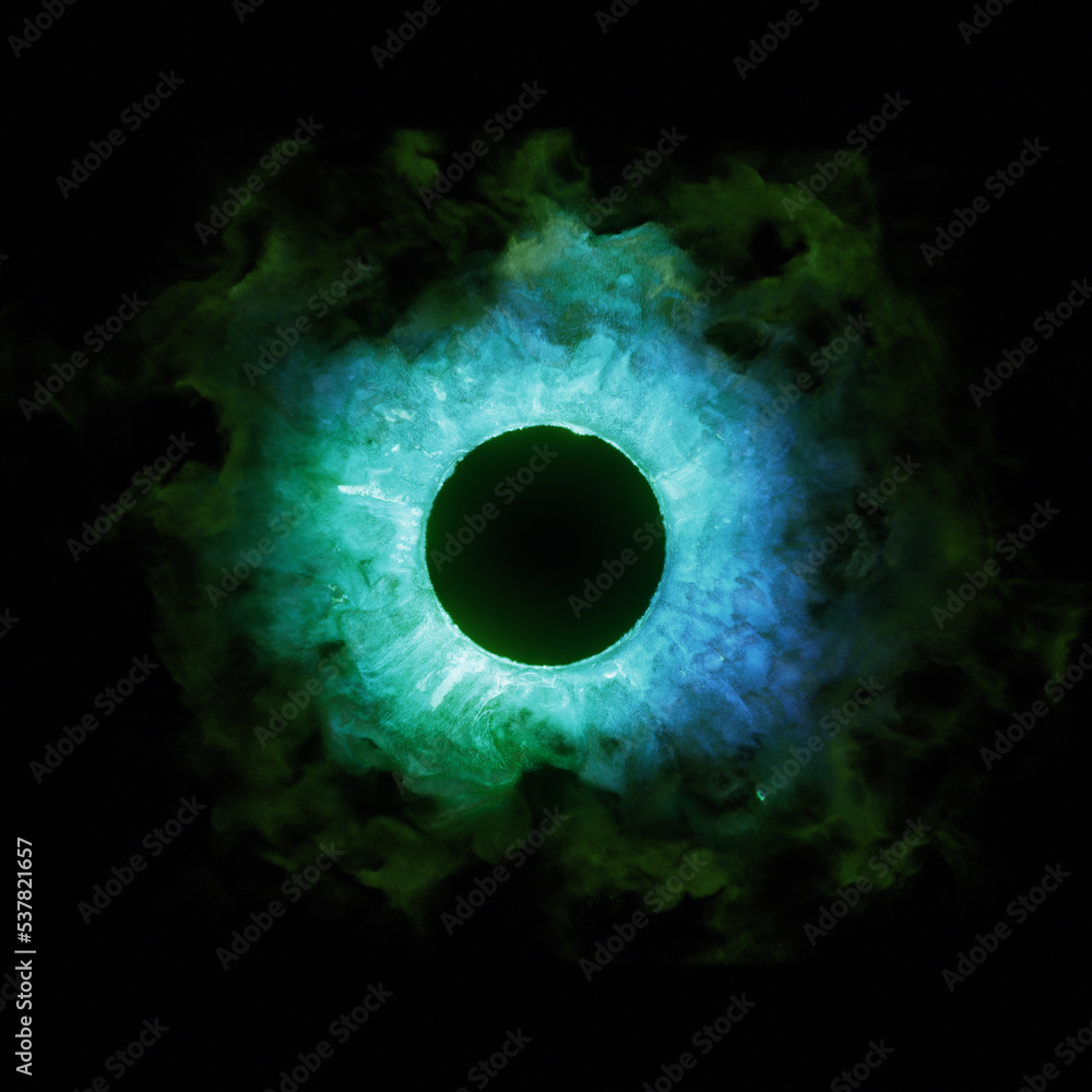 Abstract Iris, hole made of blue and green smoke on black background ...