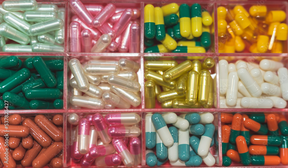 Various hard-shelled gelatin capsules of different colors in an ...