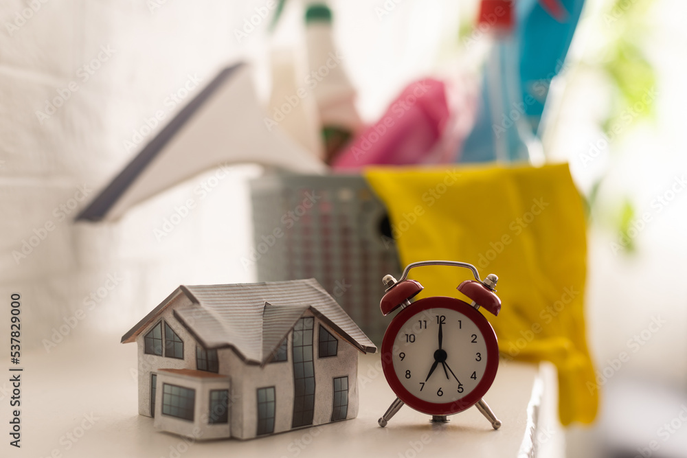 Housekeeping concept. Set of products for cleaning and a toy house ...