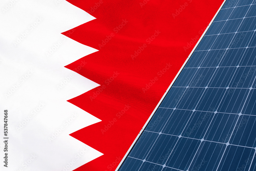 Solar panels against Bahrain flag background. Solar battery generates a ...