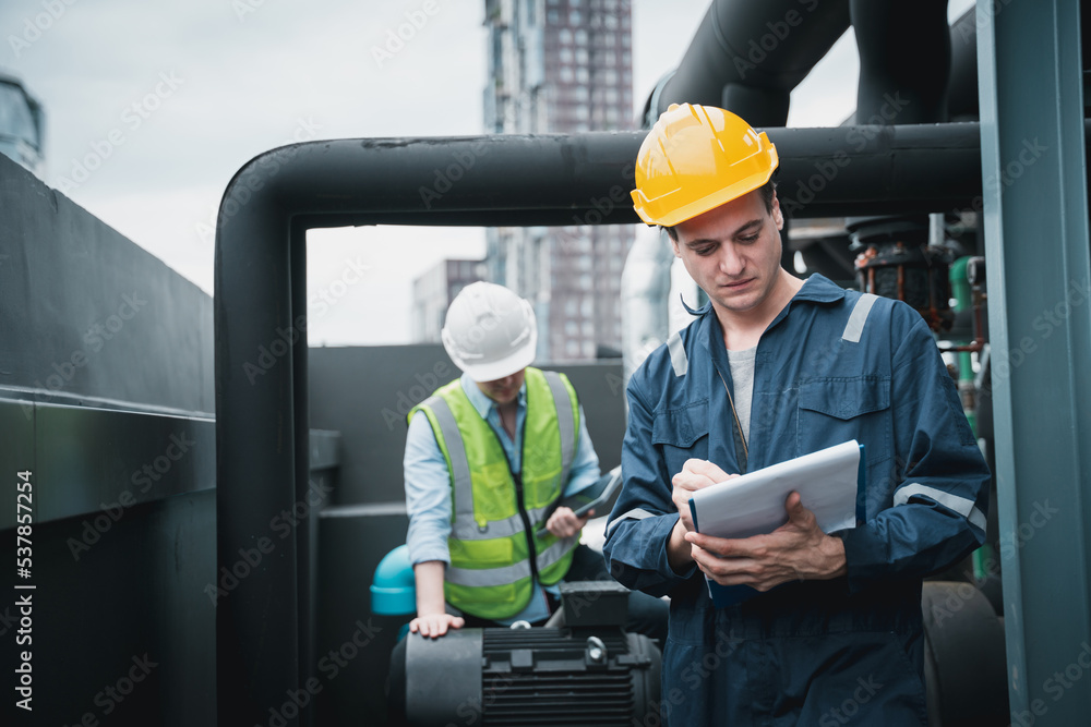 Engineer and team examining the air conditioning cooling system of a ...