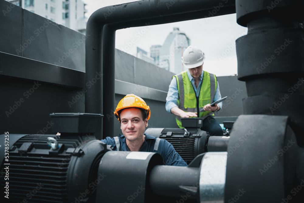 Engineer and team examining the air conditioning cooling system of a ...