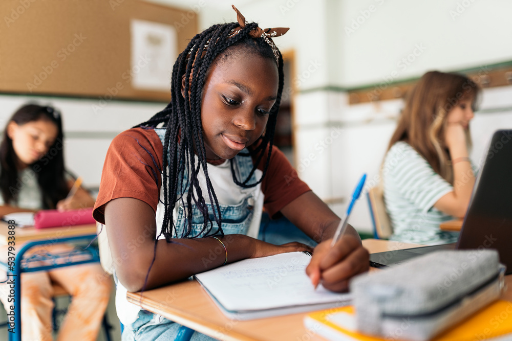 Girl taking notes Stock Photo | Adobe Stock