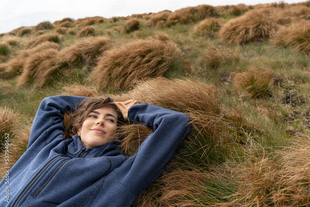 Beautiful woman is posing on nature background Stock Photo | Adobe Stock