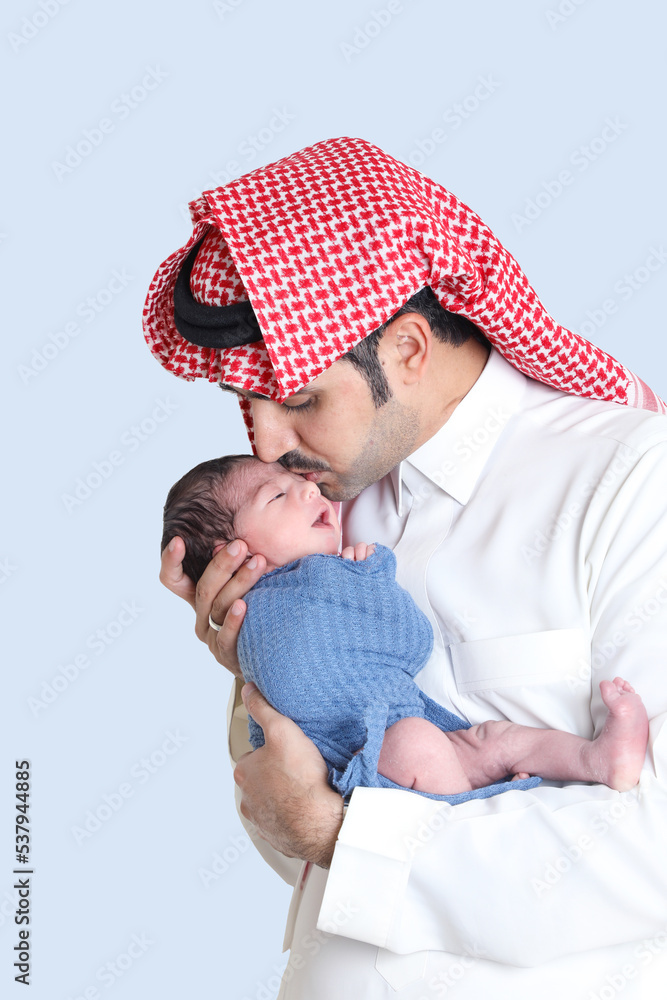 saudi muslim man in traditional dressing holding newborn baby in arms ...