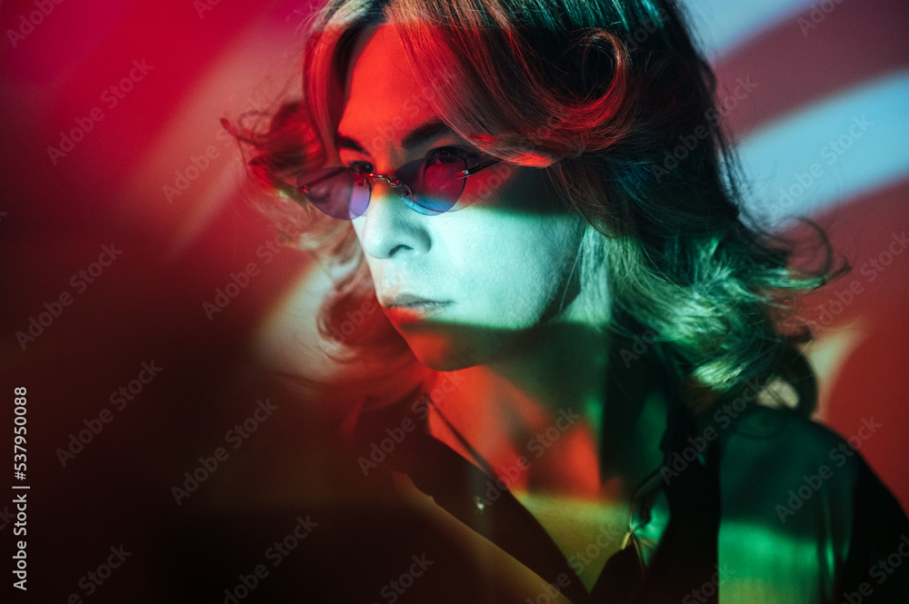 Transgender model under colorful projection Stock Photo | Adobe Stock
